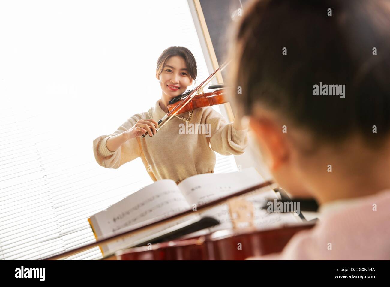 Happy children's music lessons Stock Photo - Alamy