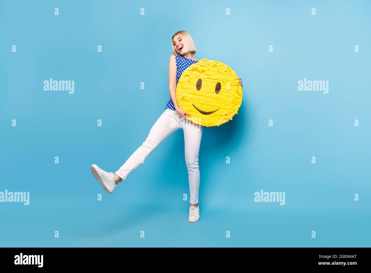 Full size photo of young girl happy positive smile hold paper pinata ...