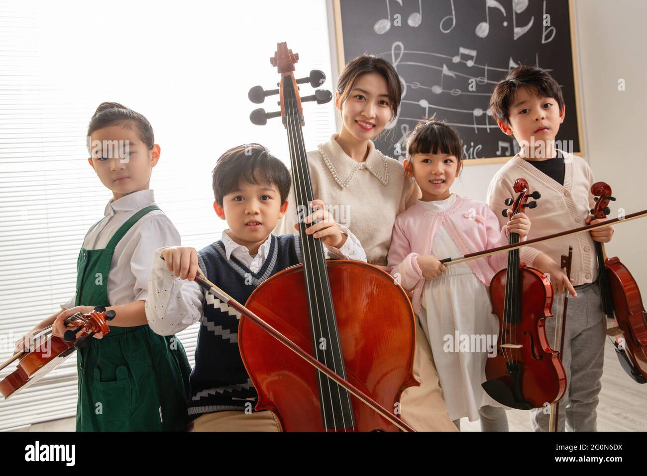 Happy children's music lessons Stock Photo - Alamy