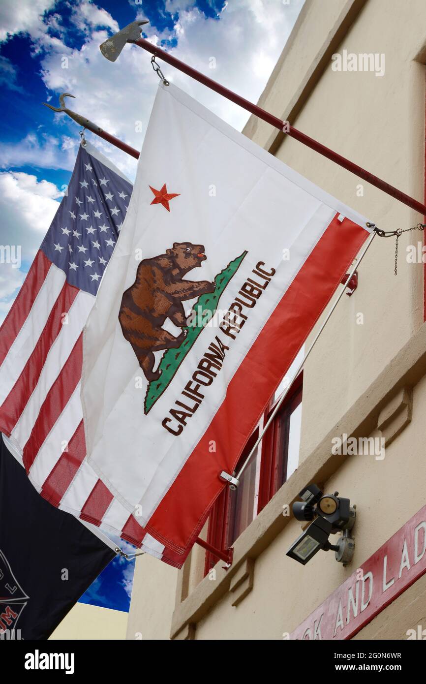 California state flag and the American flag hang together side-by-side ...
