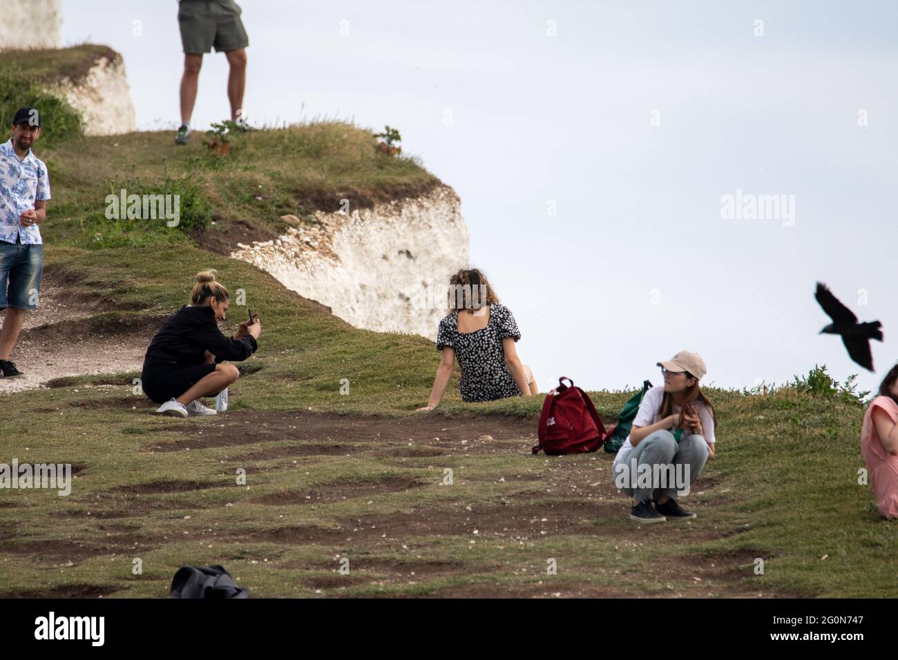 People sitting on cliff top hi-res stock photography and images - Alamy