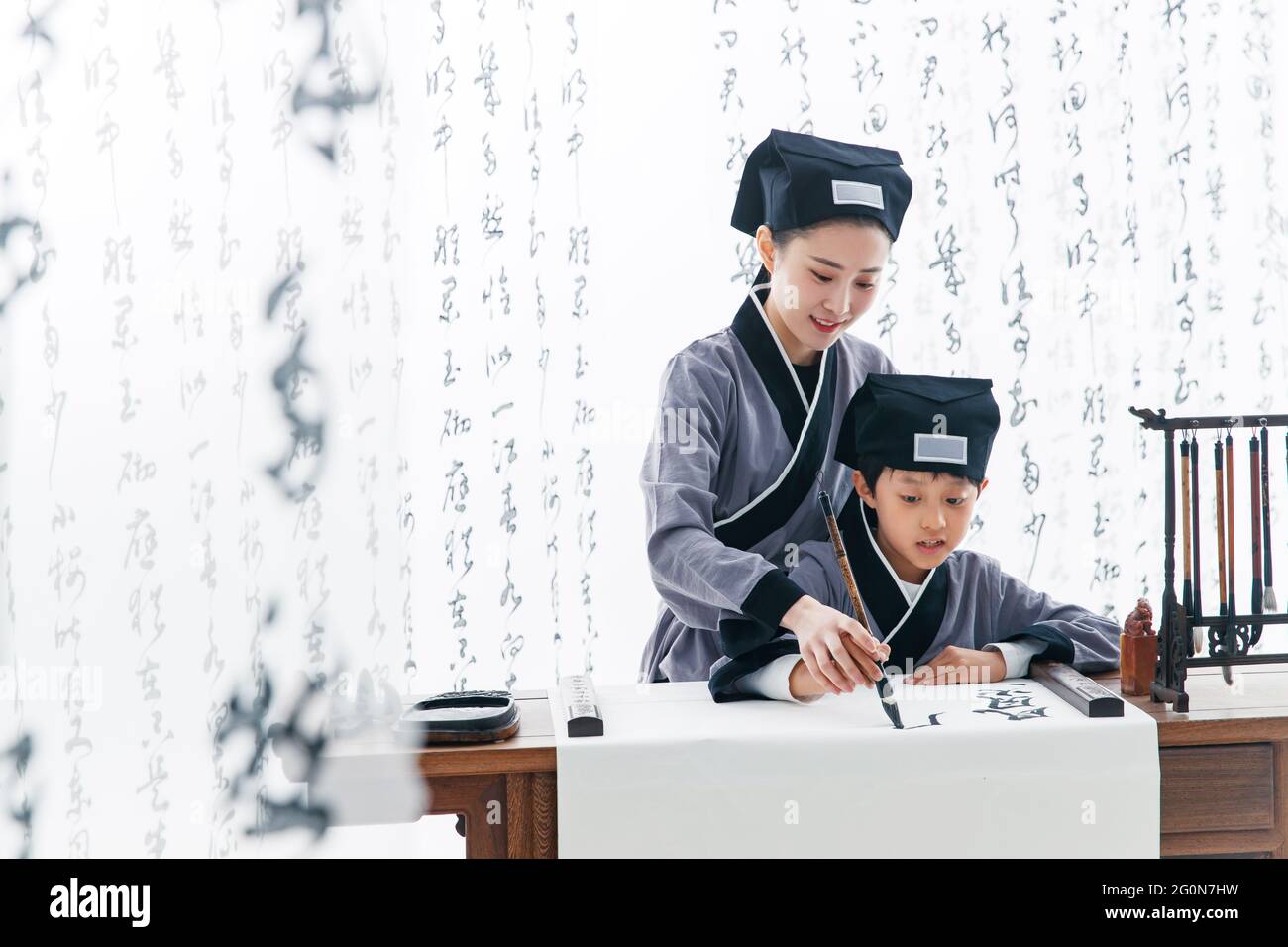 The teacher taught the pupils to learn calligraphy Stock Photo - Alamy