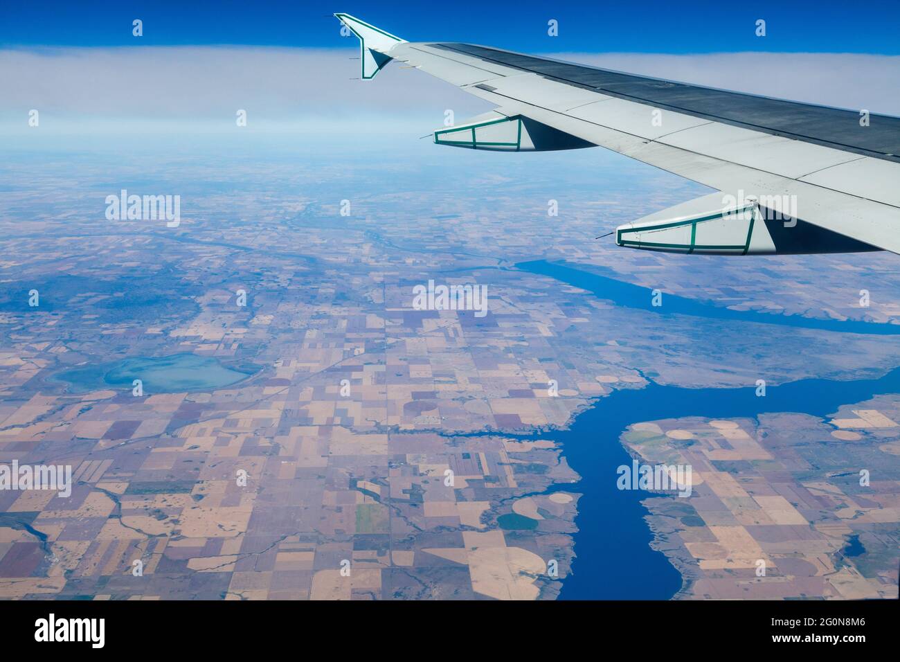 An aerial view of the Canadian prairie landscape, and airplane wing ...