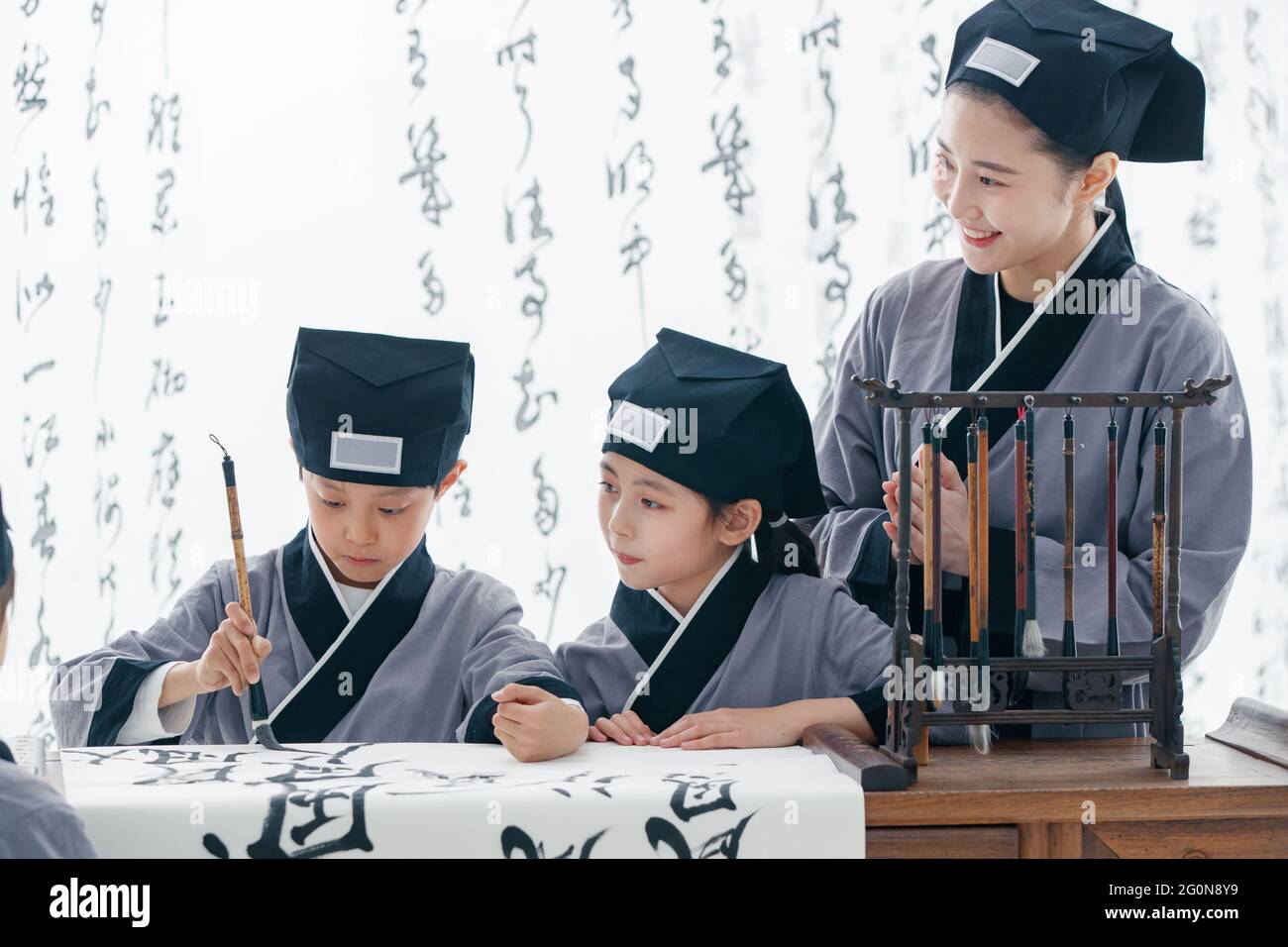 The teacher taught the pupils to learn calligraphy Stock Photo - Alamy