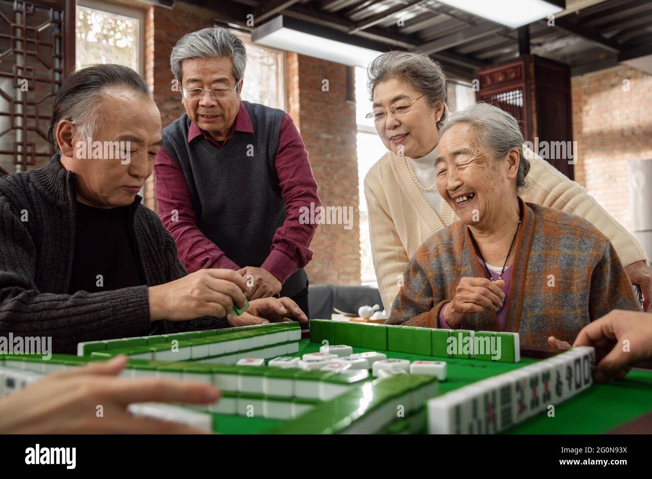 Happy old people playing mahjong Stock Photo - Alamy