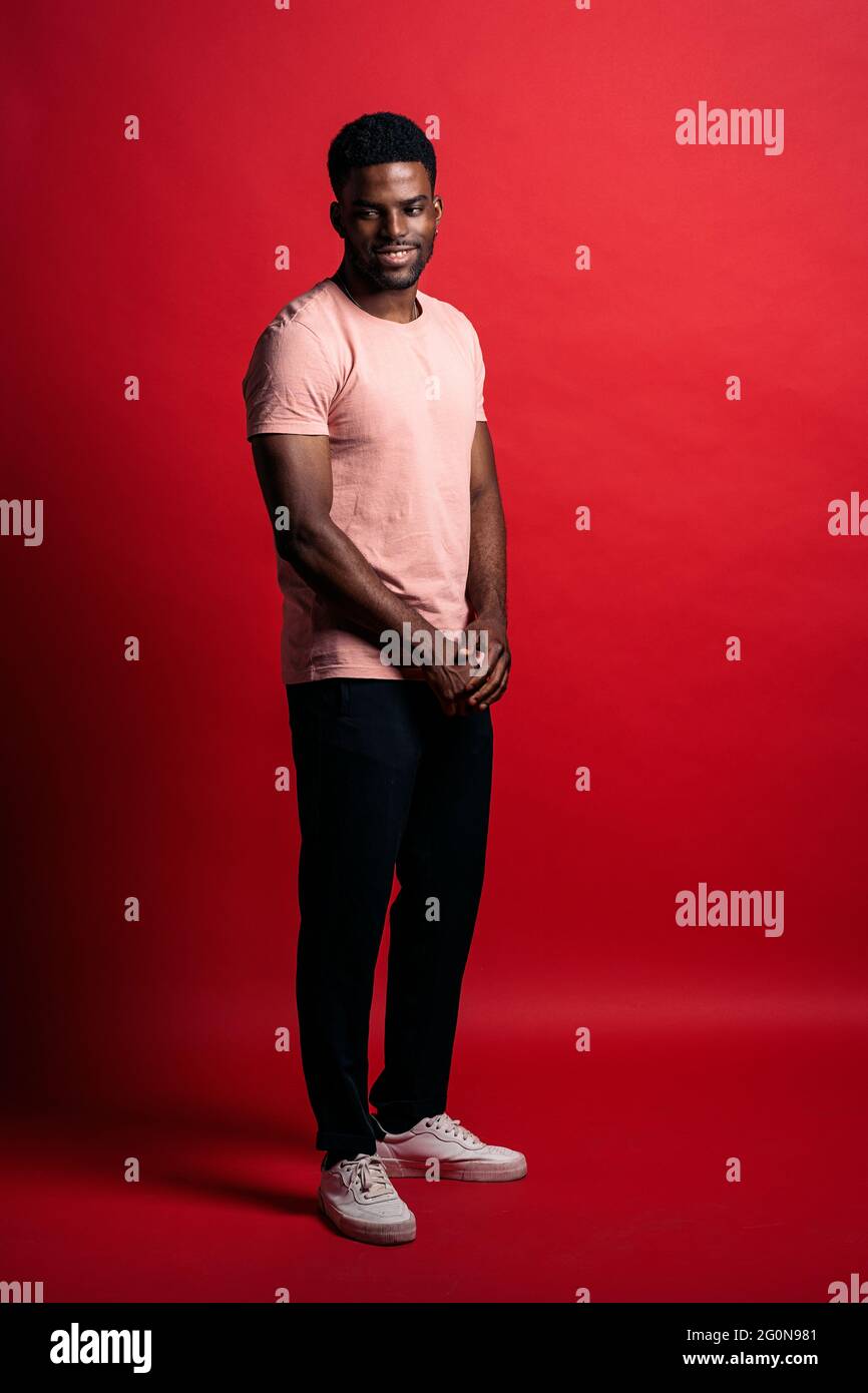 Portrait of young african man on bright red background Stock Photo - Alamy