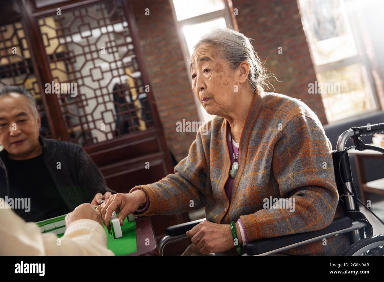 Happy old people playing mahjong Stock Photo - Alamy