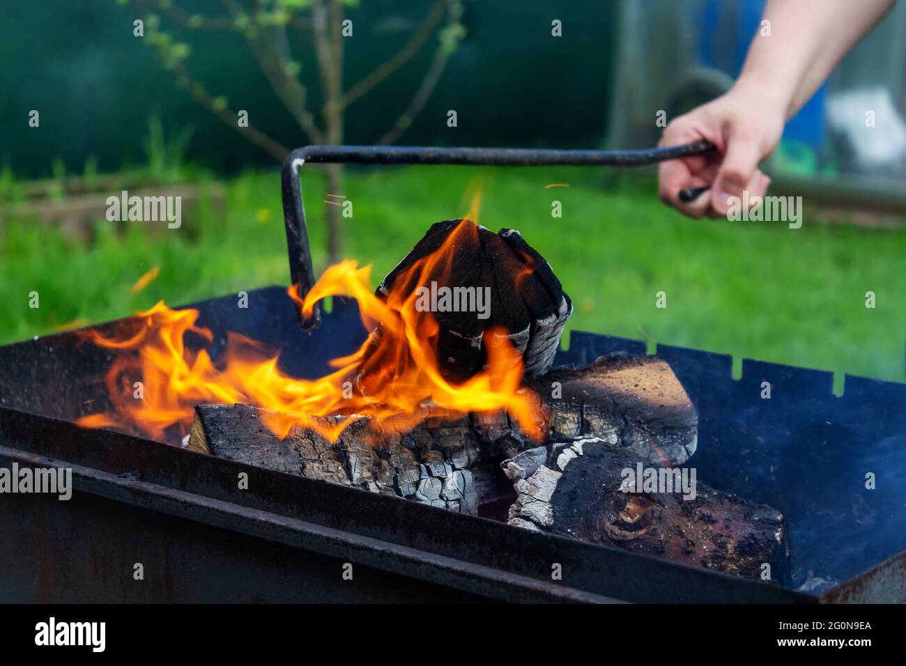 Summer backyard barbecue. Making fire in grill Stock Photo - Alamy