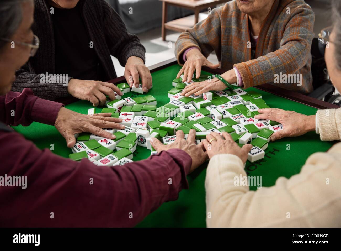 Happy old people playing mahjong Stock Photo - Alamy
