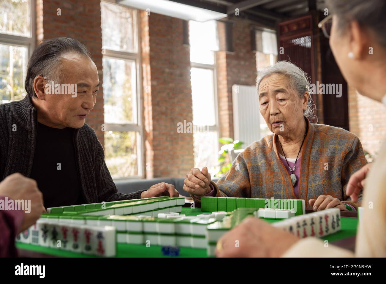 Happy old people playing mahjong Stock Photo - Alamy