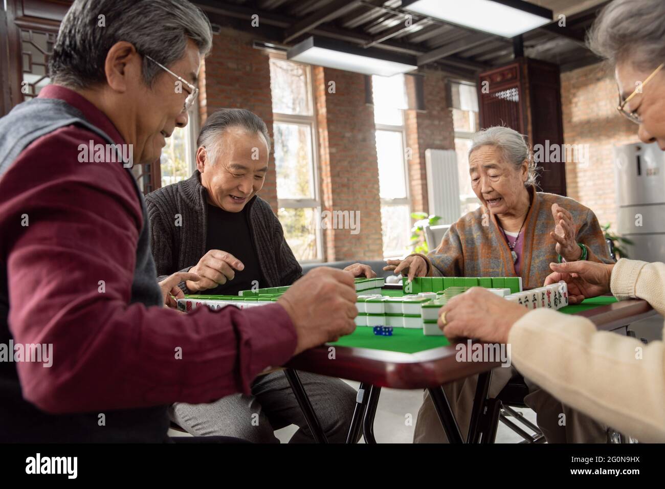 Happy old people playing mahjong Stock Photo - Alamy