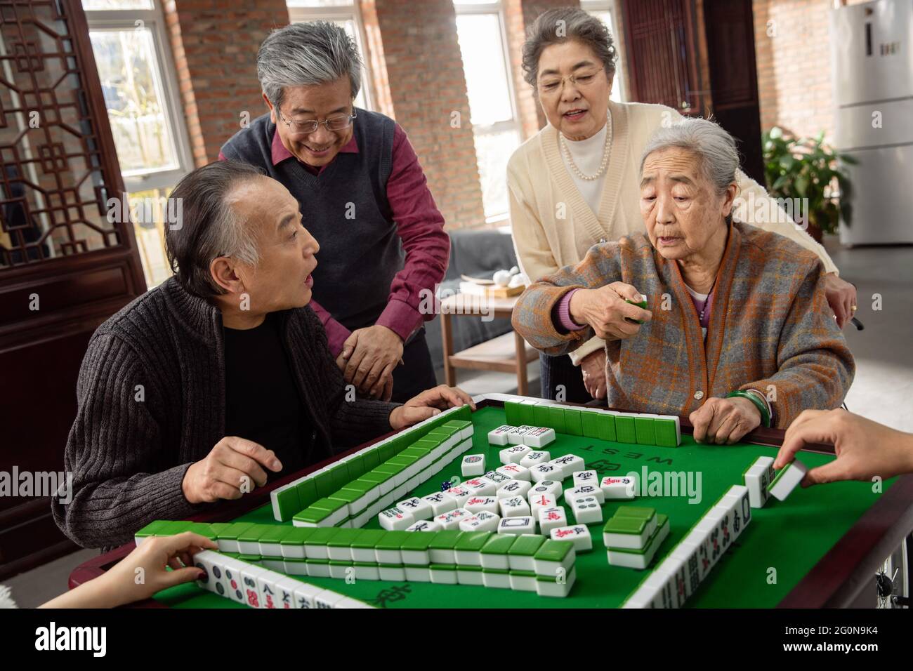 Happy old people playing mahjong Stock Photo - Alamy