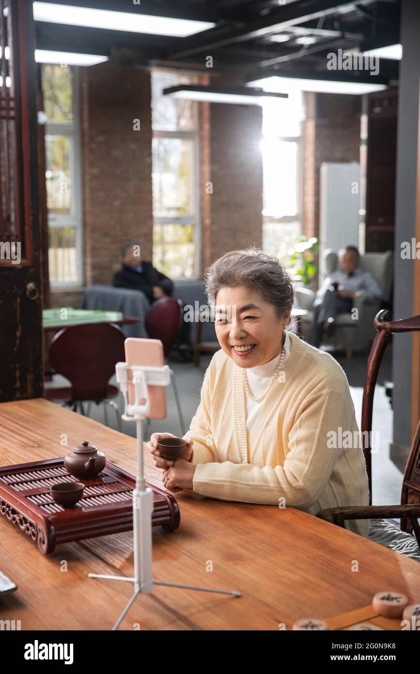 Happy old people use cell phones to see video Stock Photo - Alamy