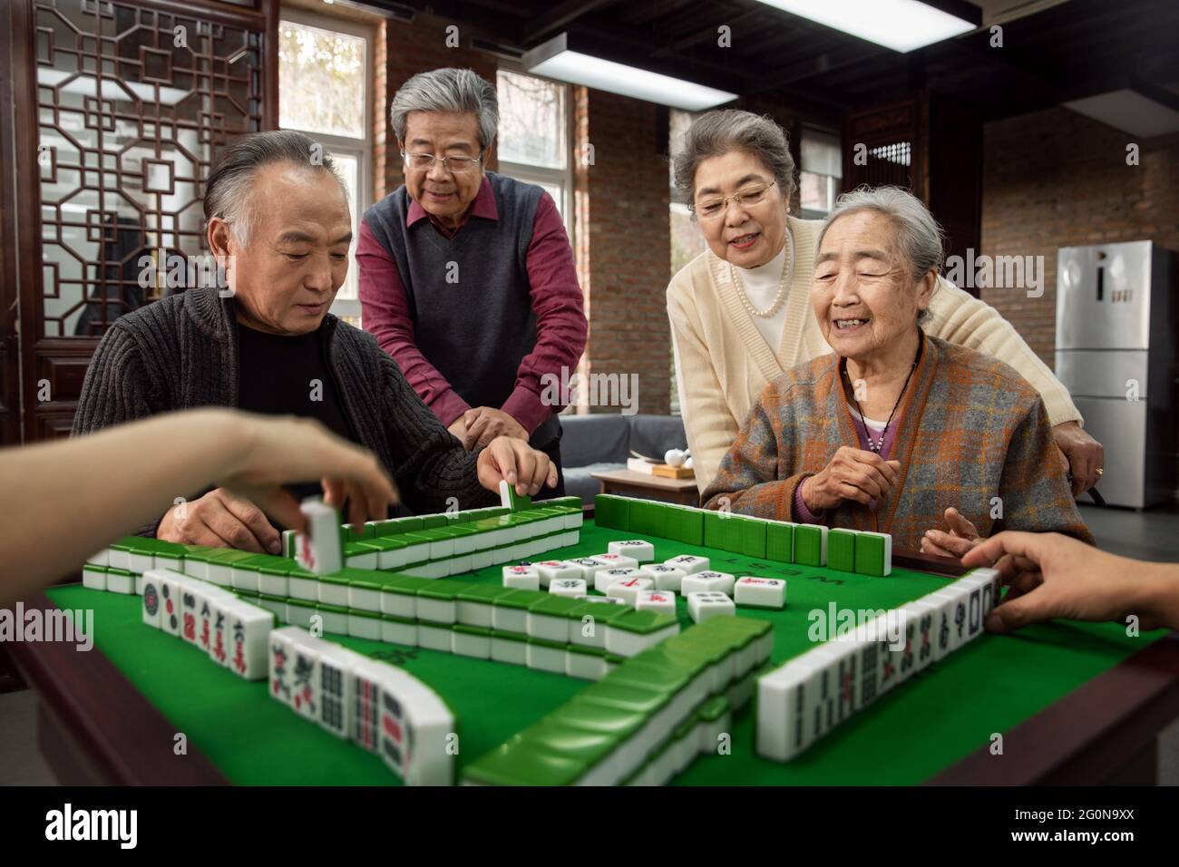 Happy old people playing mahjong Stock Photo - Alamy