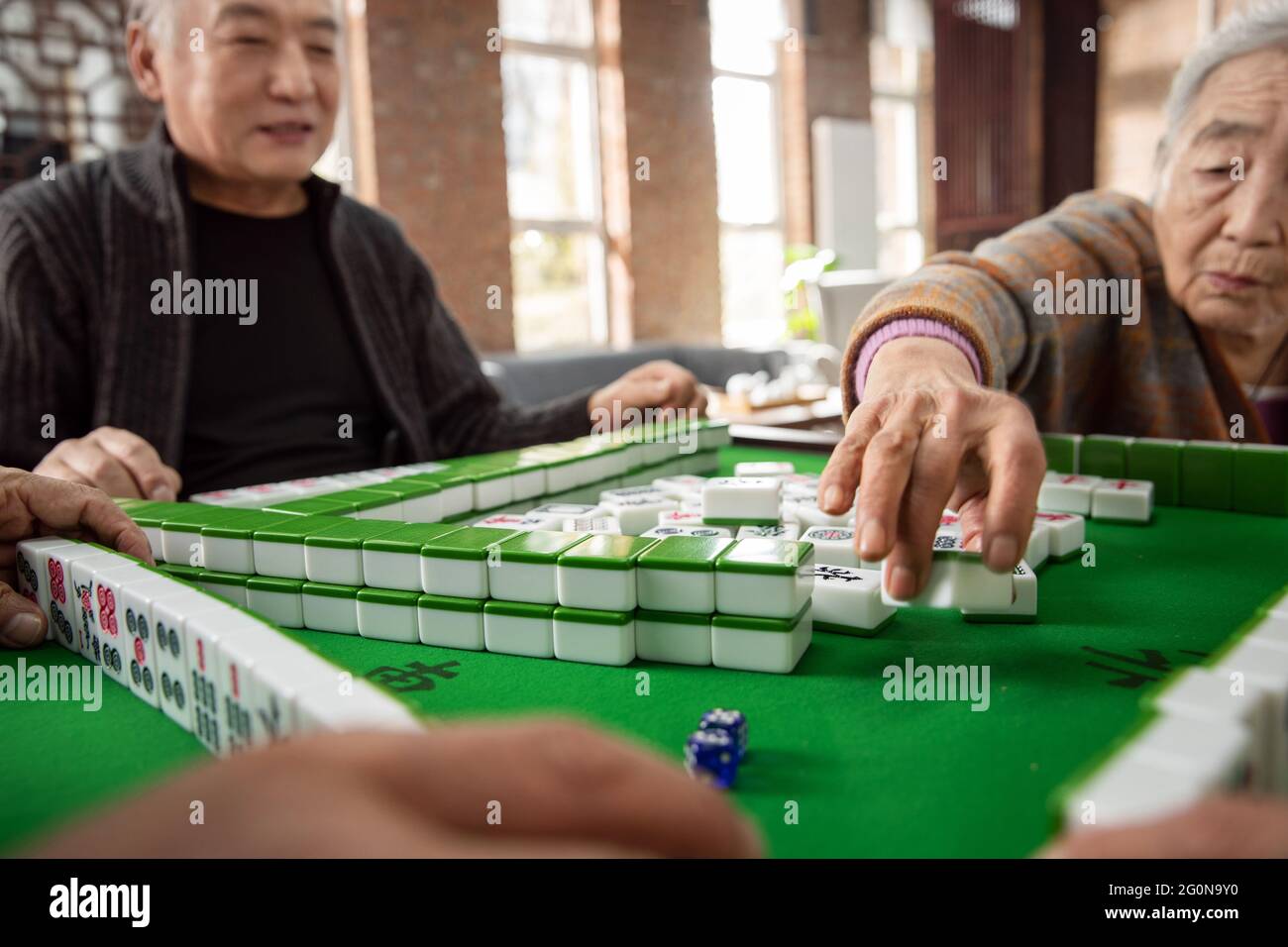 Happy old people playing mahjong Stock Photo - Alamy