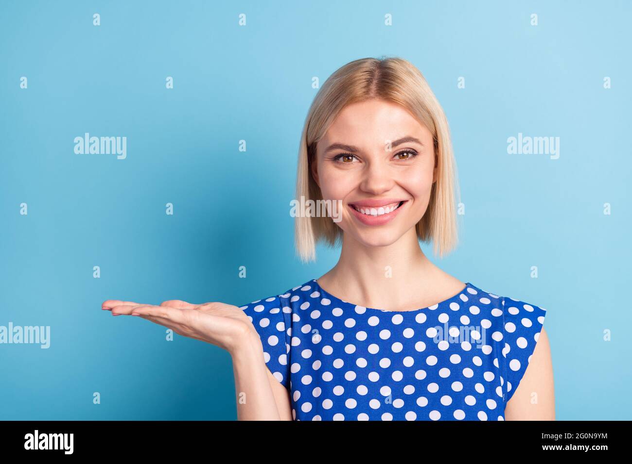 Photo of young girl happy positive smile demonstrate hand product promo ...