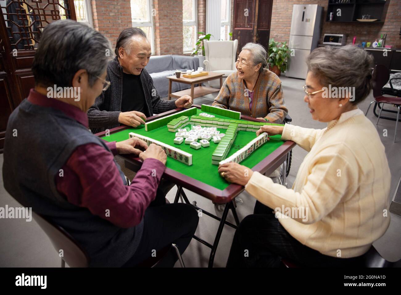 Happy old people playing mahjong Stock Photo - Alamy