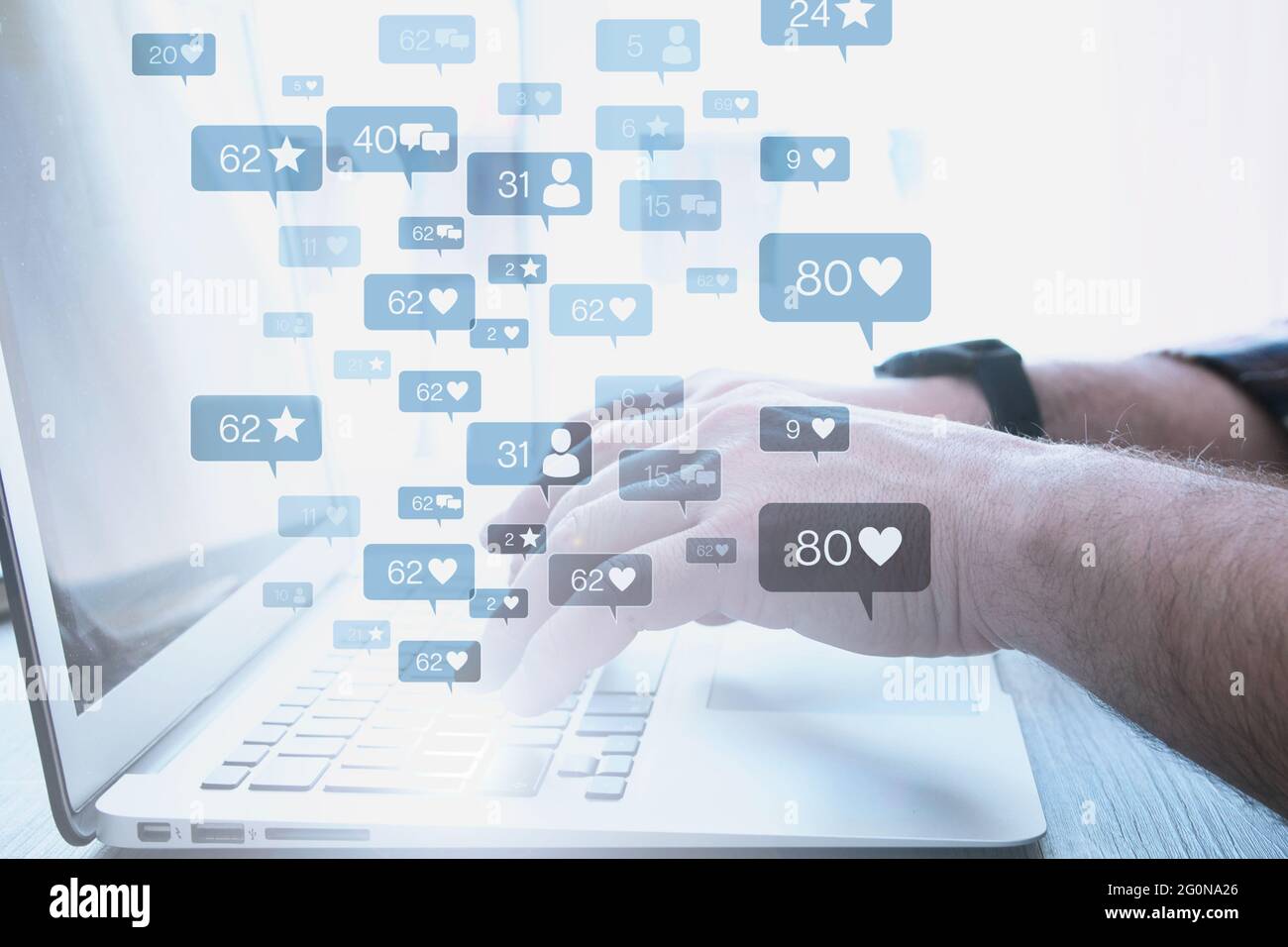 Businessman hands using laptop with social media icons on blurry indoor ...