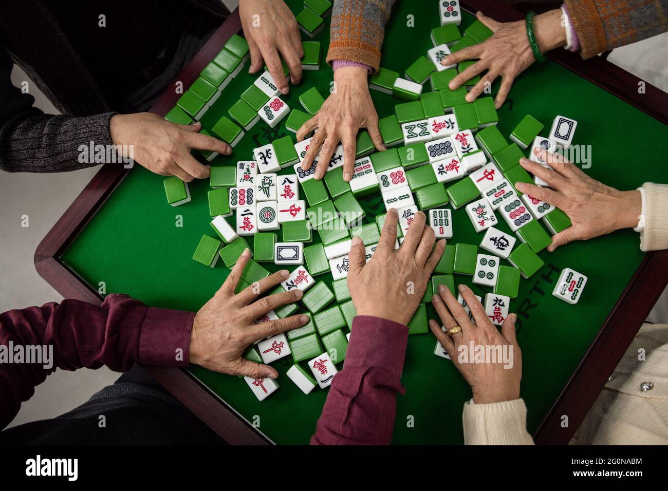 Happy old people playing mahjong Stock Photo - Alamy