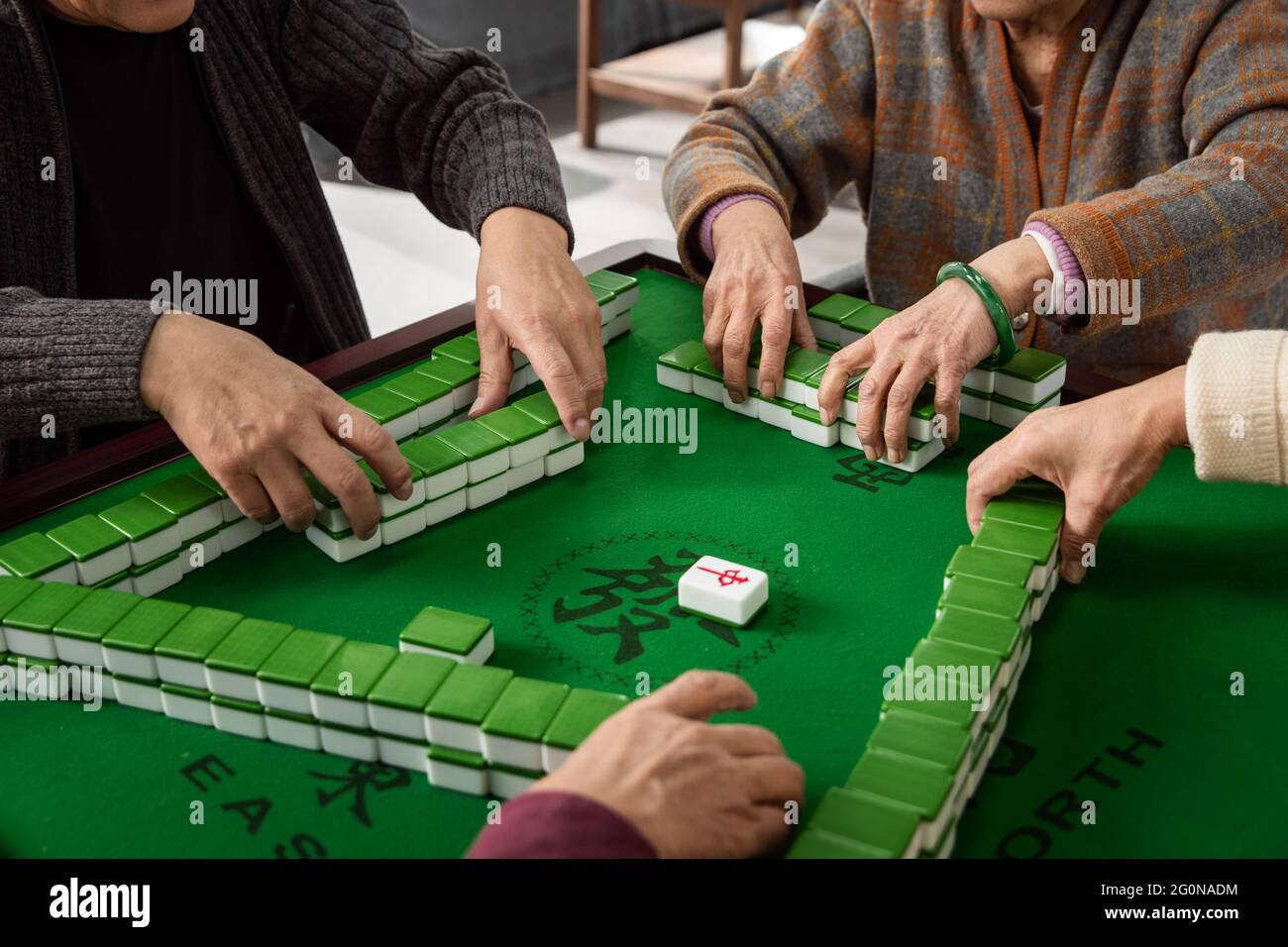 Happy old people playing mahjong Stock Photo - Alamy