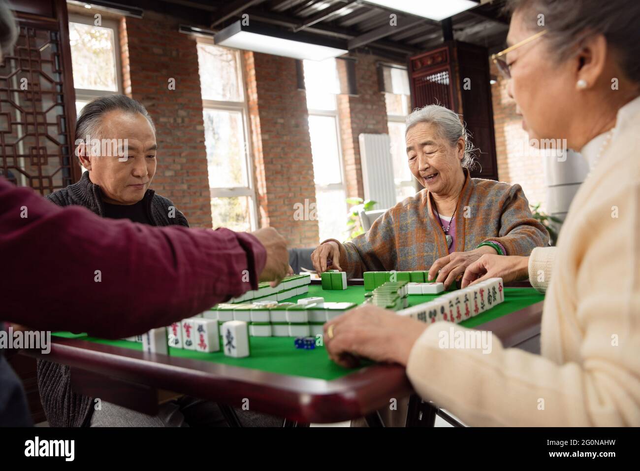 Happy old people playing mahjong Stock Photo - Alamy