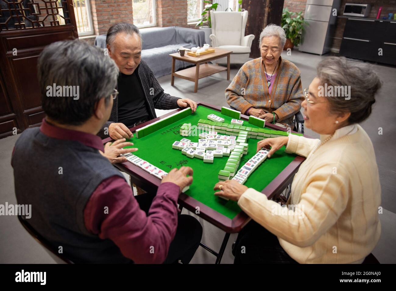 Happy old people playing mahjong Stock Photo - Alamy