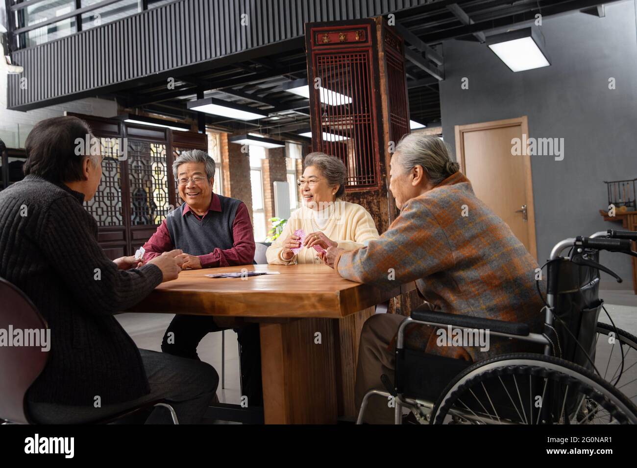 Four elderly friends playing cards hi-res stock photography and images ...