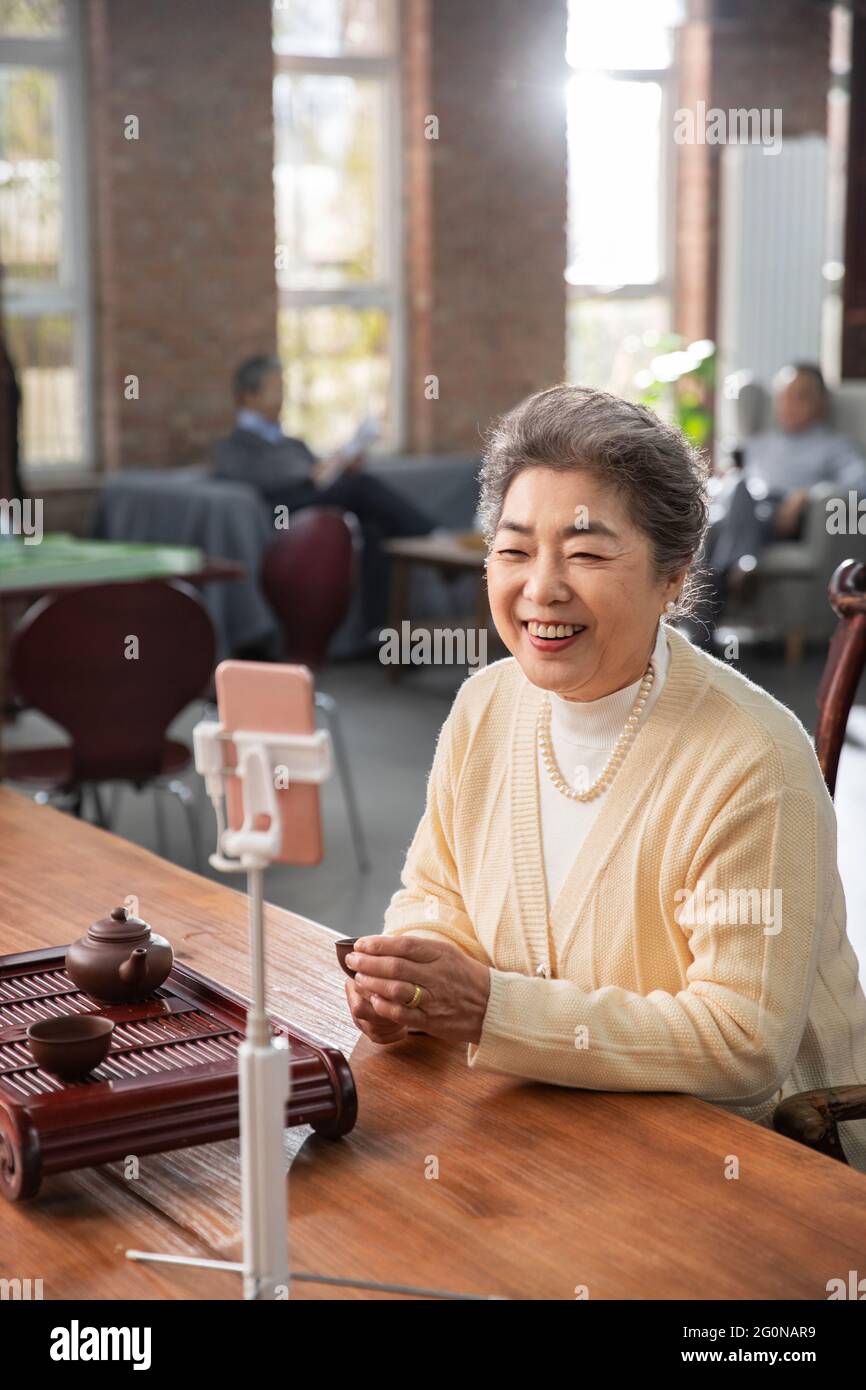 Happy old people use cell phones to see video Stock Photo - Alamy