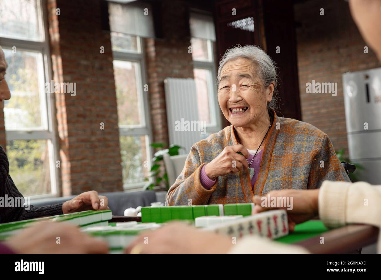 Happy old people playing mahjong Stock Photo - Alamy