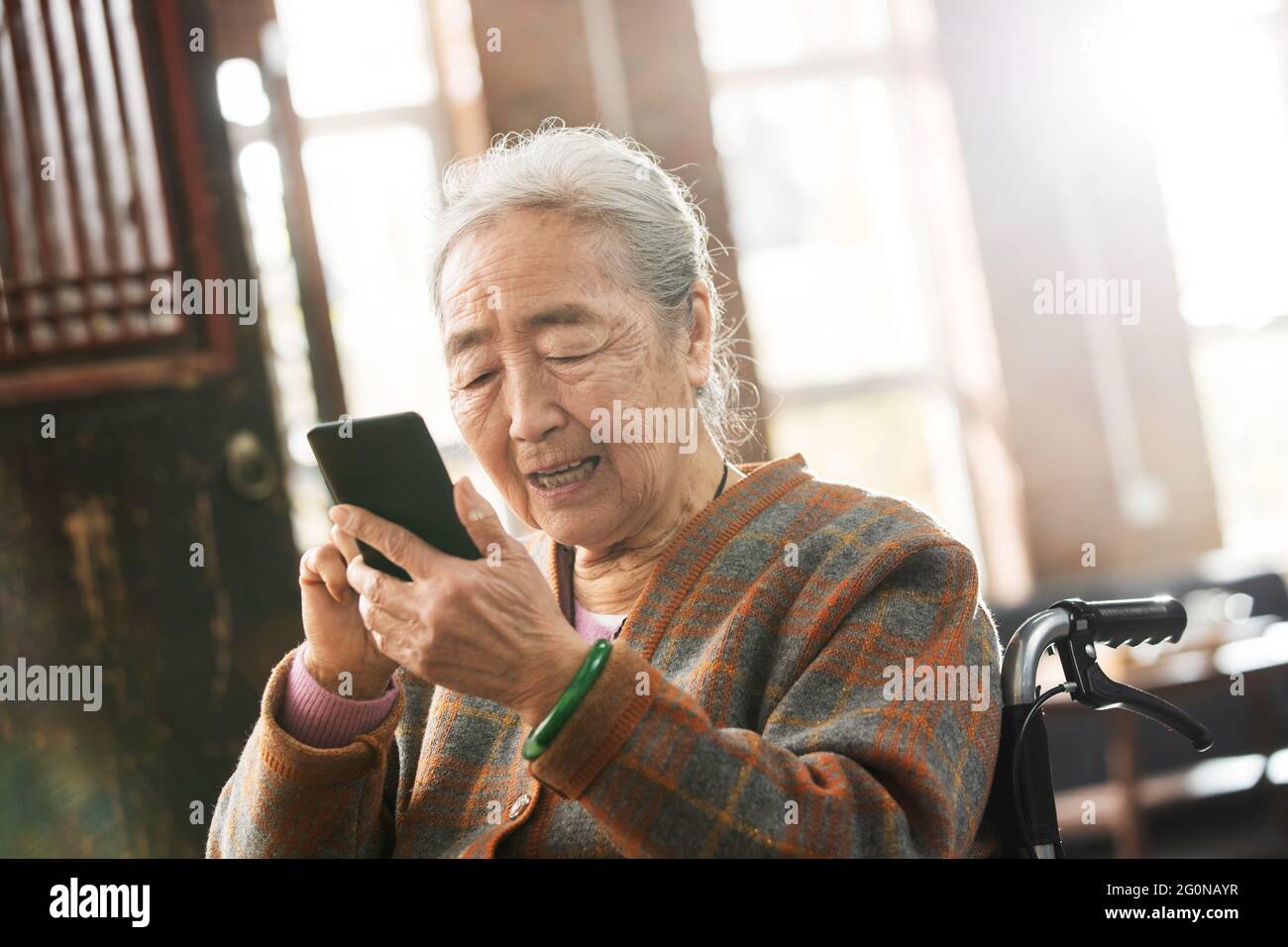The elderly using a mobile phone video Stock Photo - Alamy