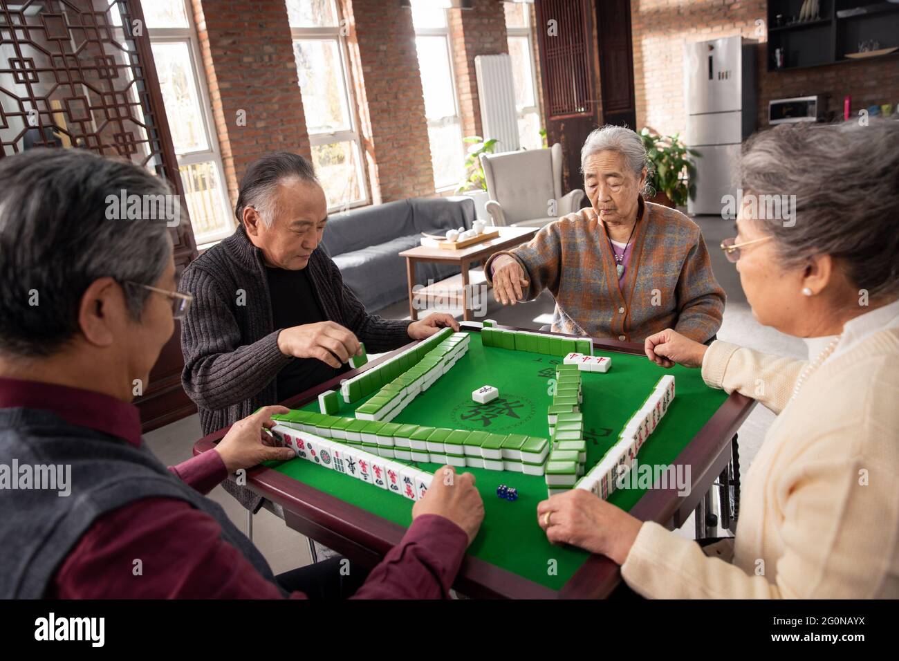 Happy old people playing mahjong Stock Photo - Alamy
