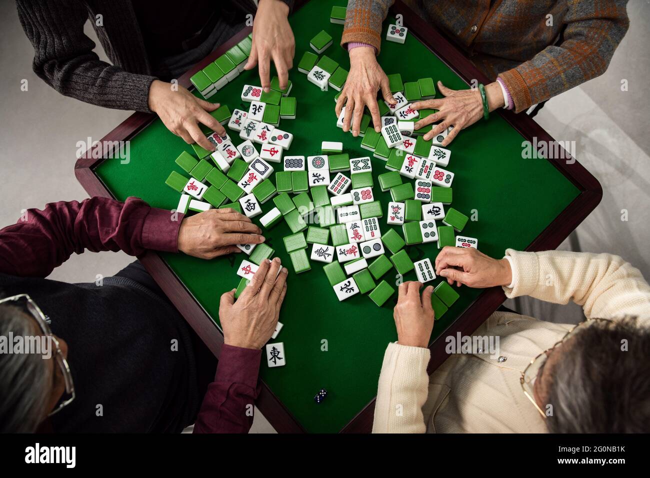 Happy old people playing mahjong Stock Photo - Alamy