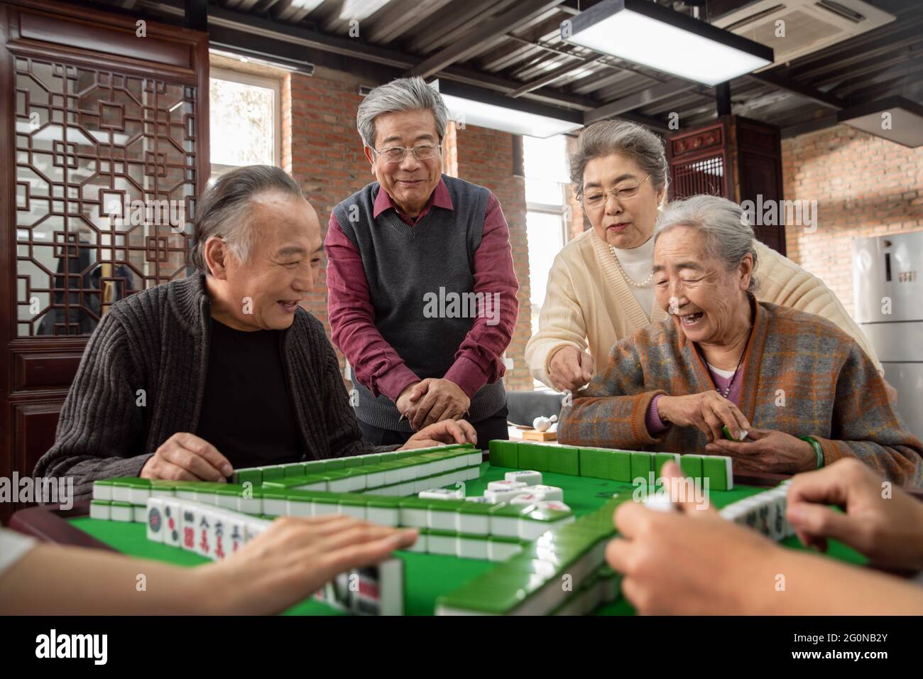 Happy old people playing mahjong Stock Photo - Alamy
