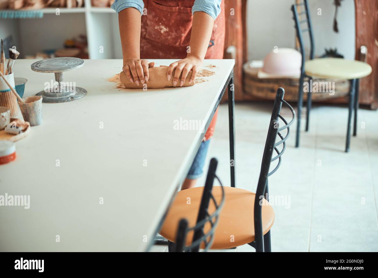 Female ceramist hands kneading clay in pottery workshop Stock Photo - Alamy