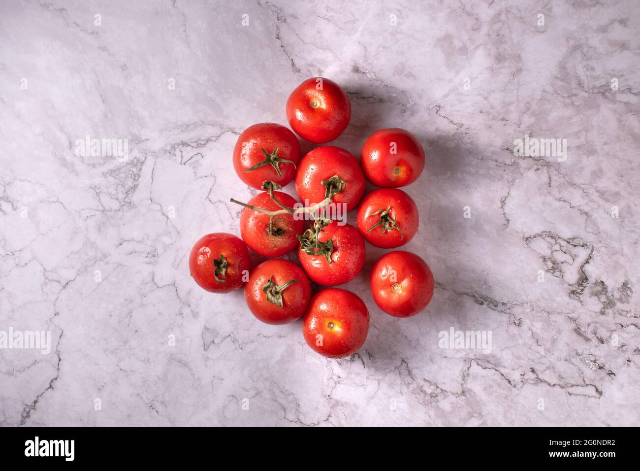 Set of wet tomatoes on a marble table Stock Photo - Alamy