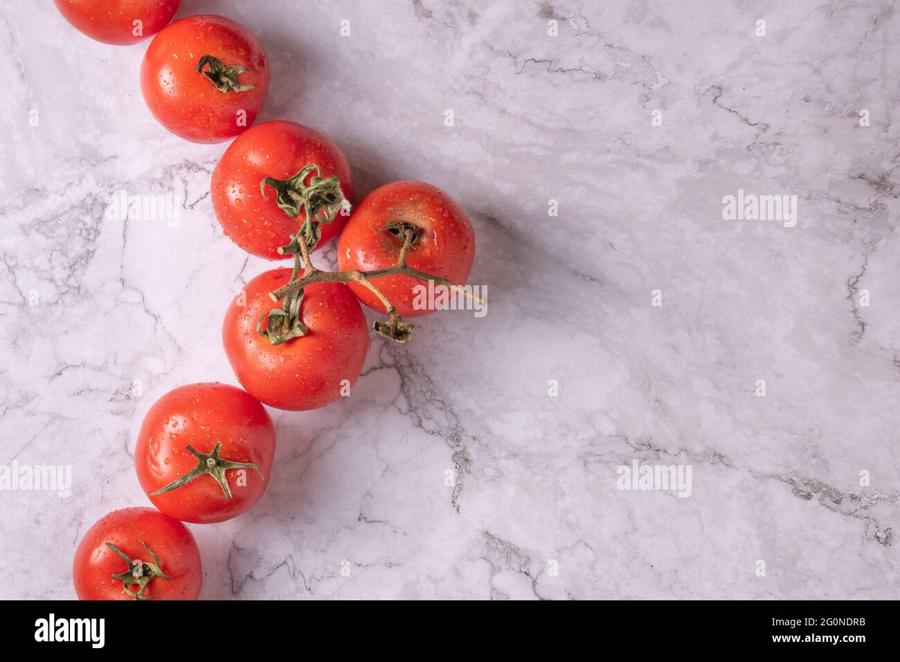 Tomatoes lined up in the shape of an arrow on a marble table Stock ...