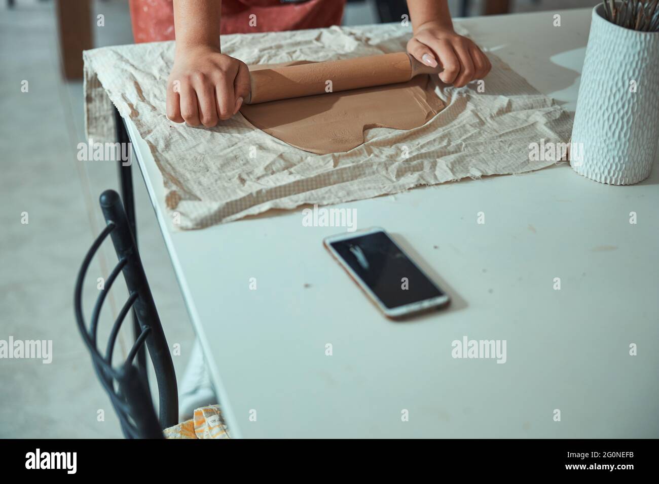 Female hands rolling polymer clay in pottery workshop Stock Photo - Alamy