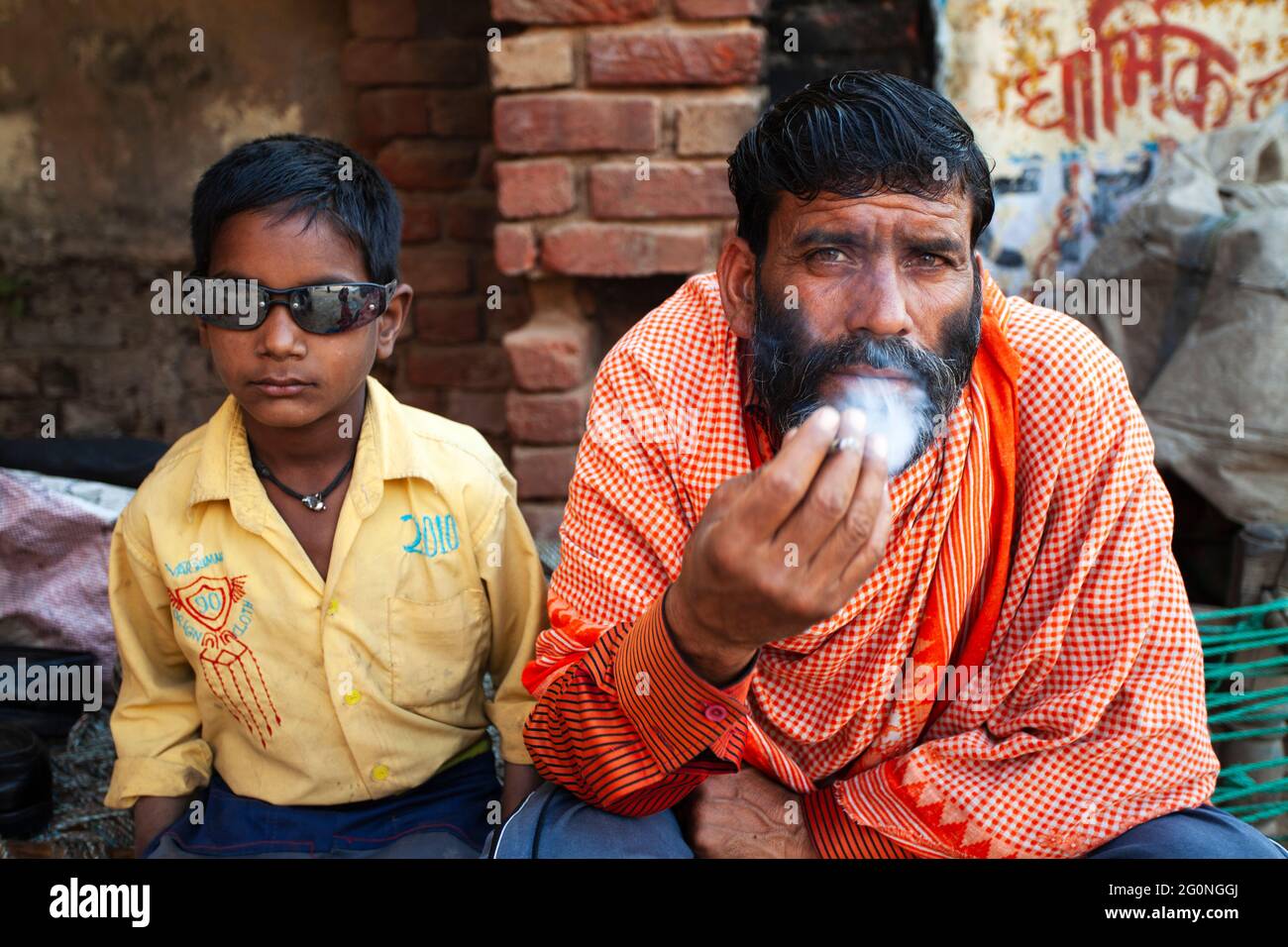 Father smoking with his son wearing sunglasses Stock Photo - Alamy