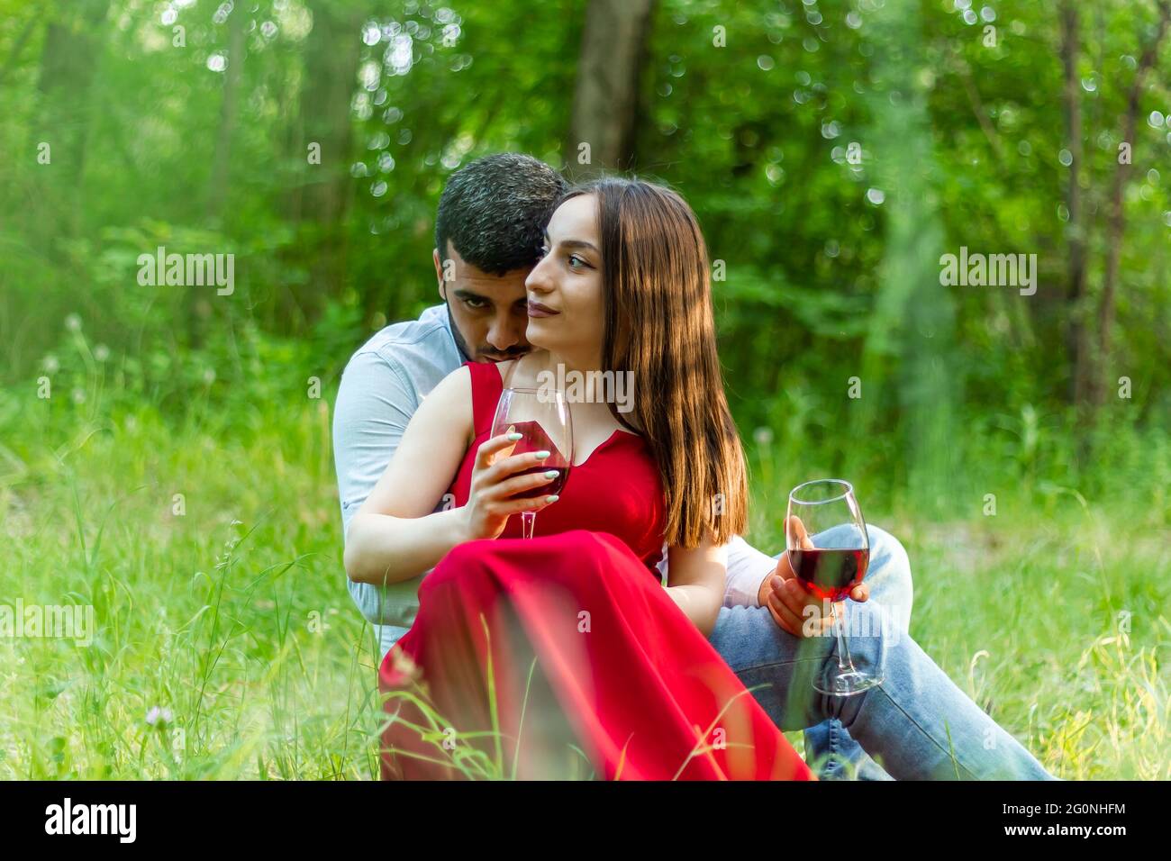 Happy Couple Having Fun In The Park Couple Drinking Red Wine In The