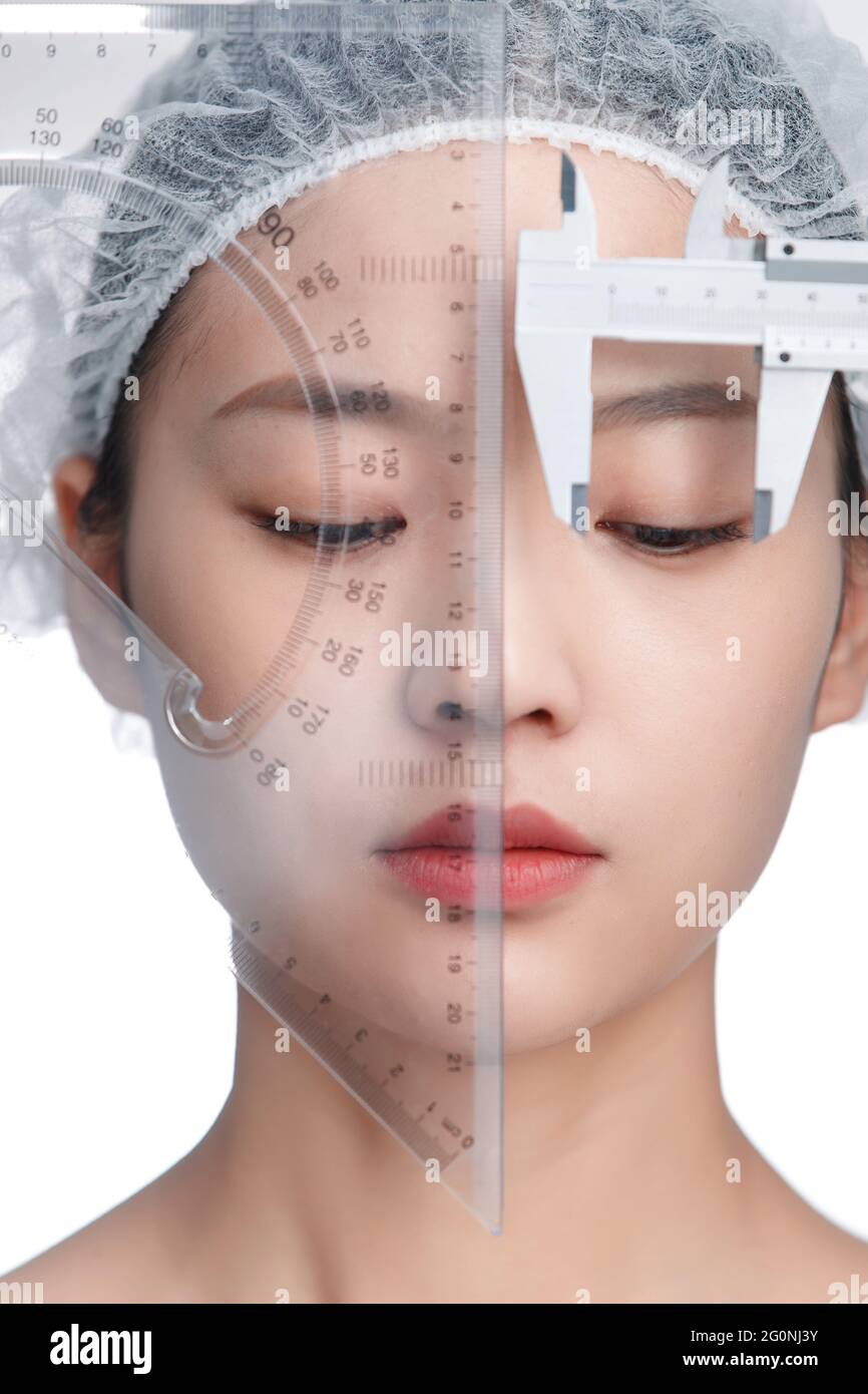 Young women face is measured with a caliper Stock Photo - Alamy