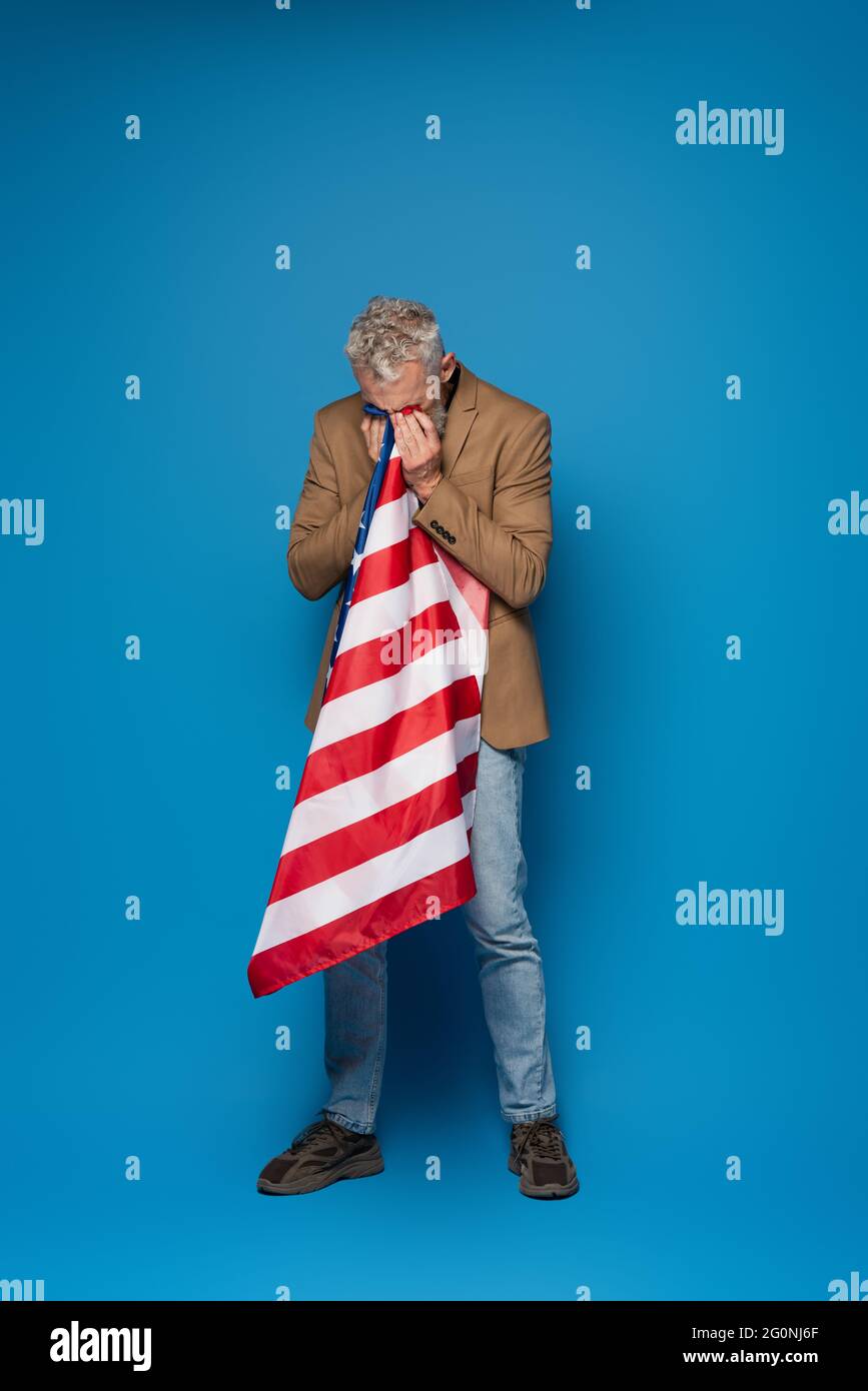 full length of patriotic middle aged man crying and covering face with ...