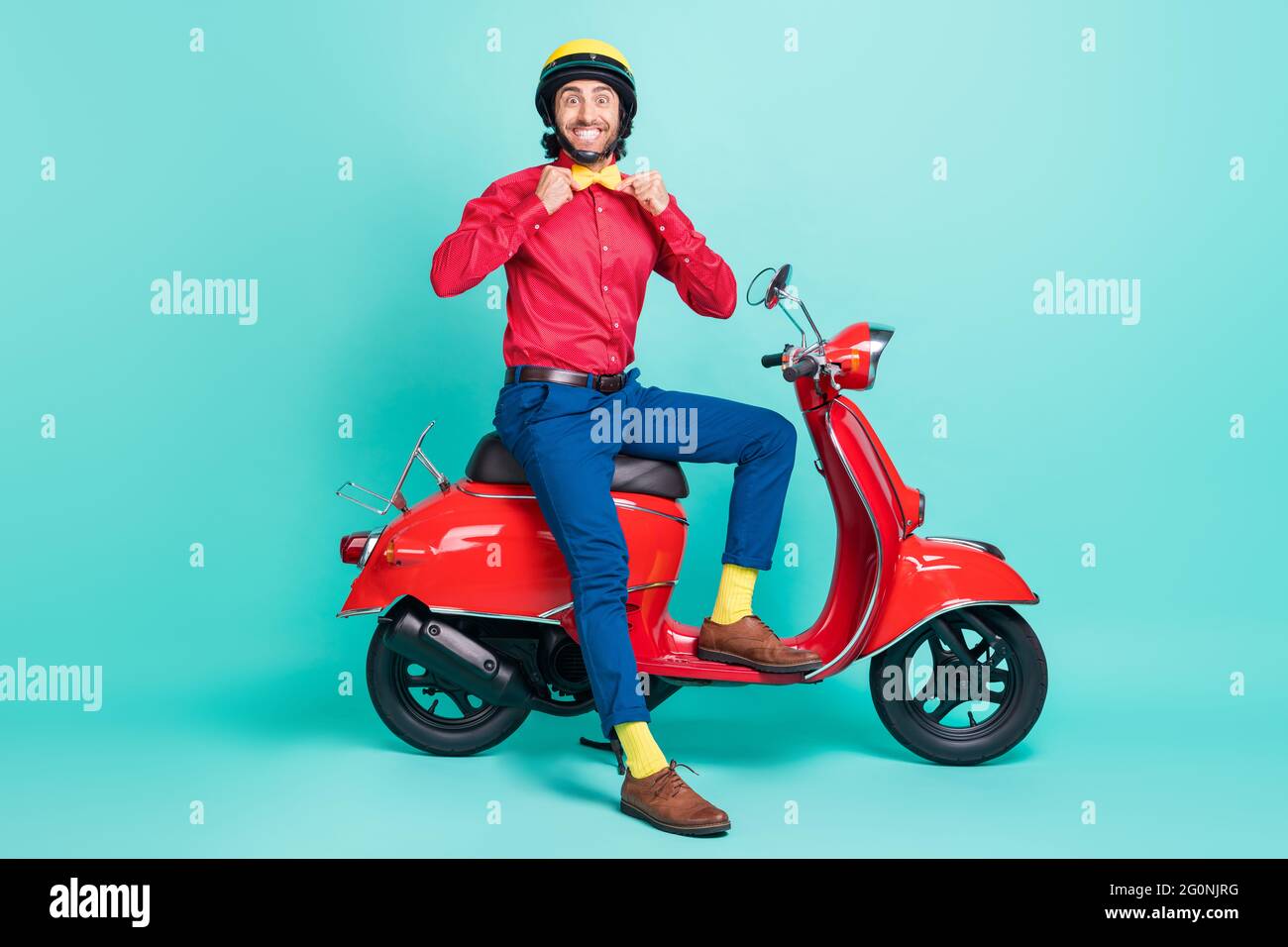 Full size photo of funky smiling handsome gentleman sit moped adjusting ...
