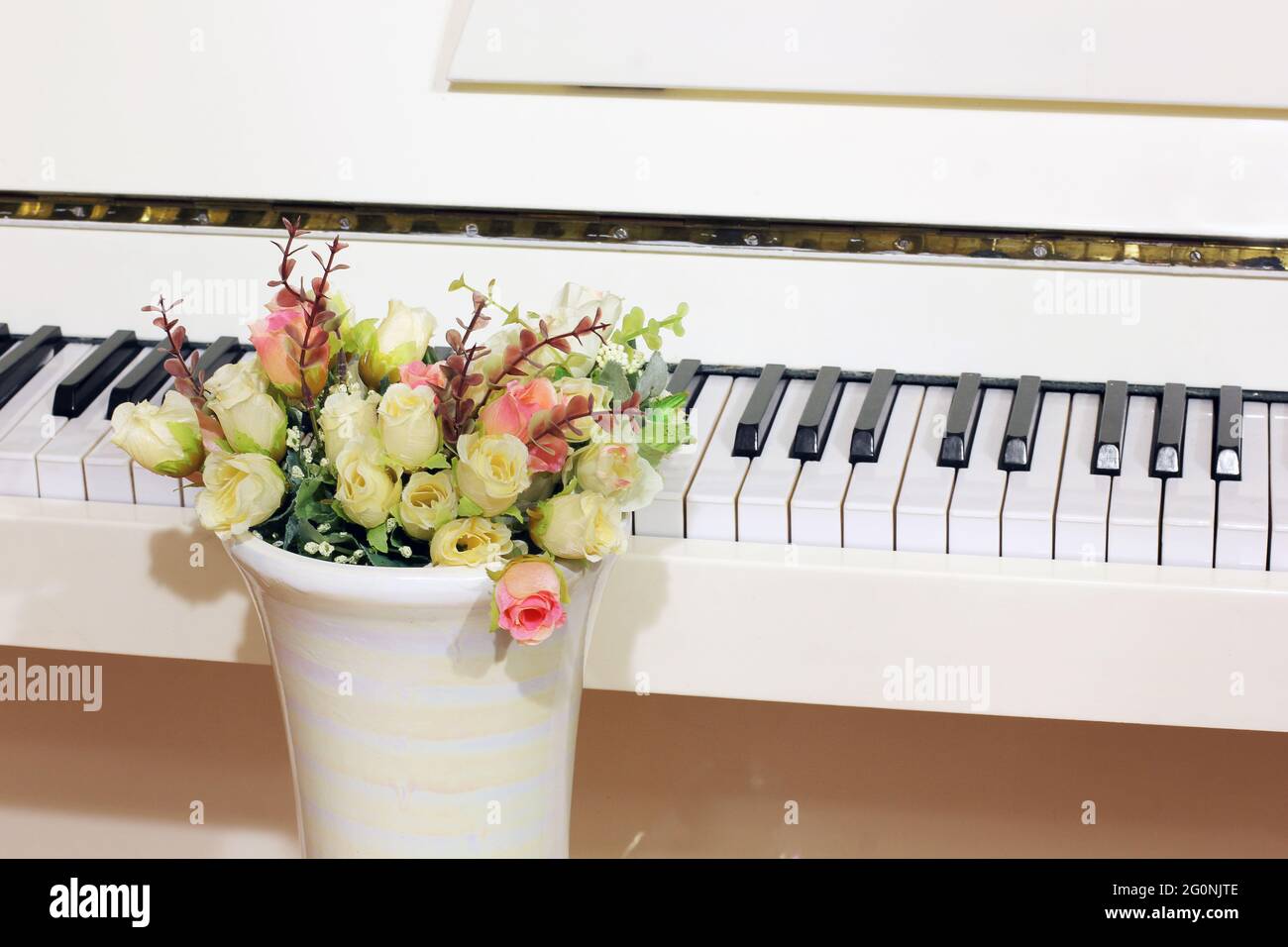 Vase with flowers and piano. Roses and musical instrument Stock Photo ...