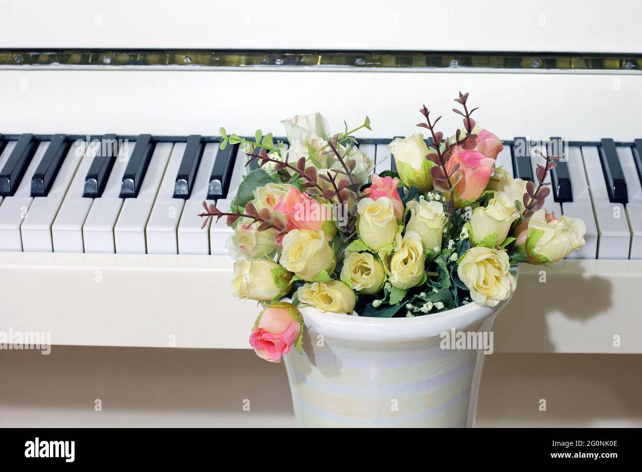 Vase with flowers and piano. Roses and musical instrument Stock Photo ...