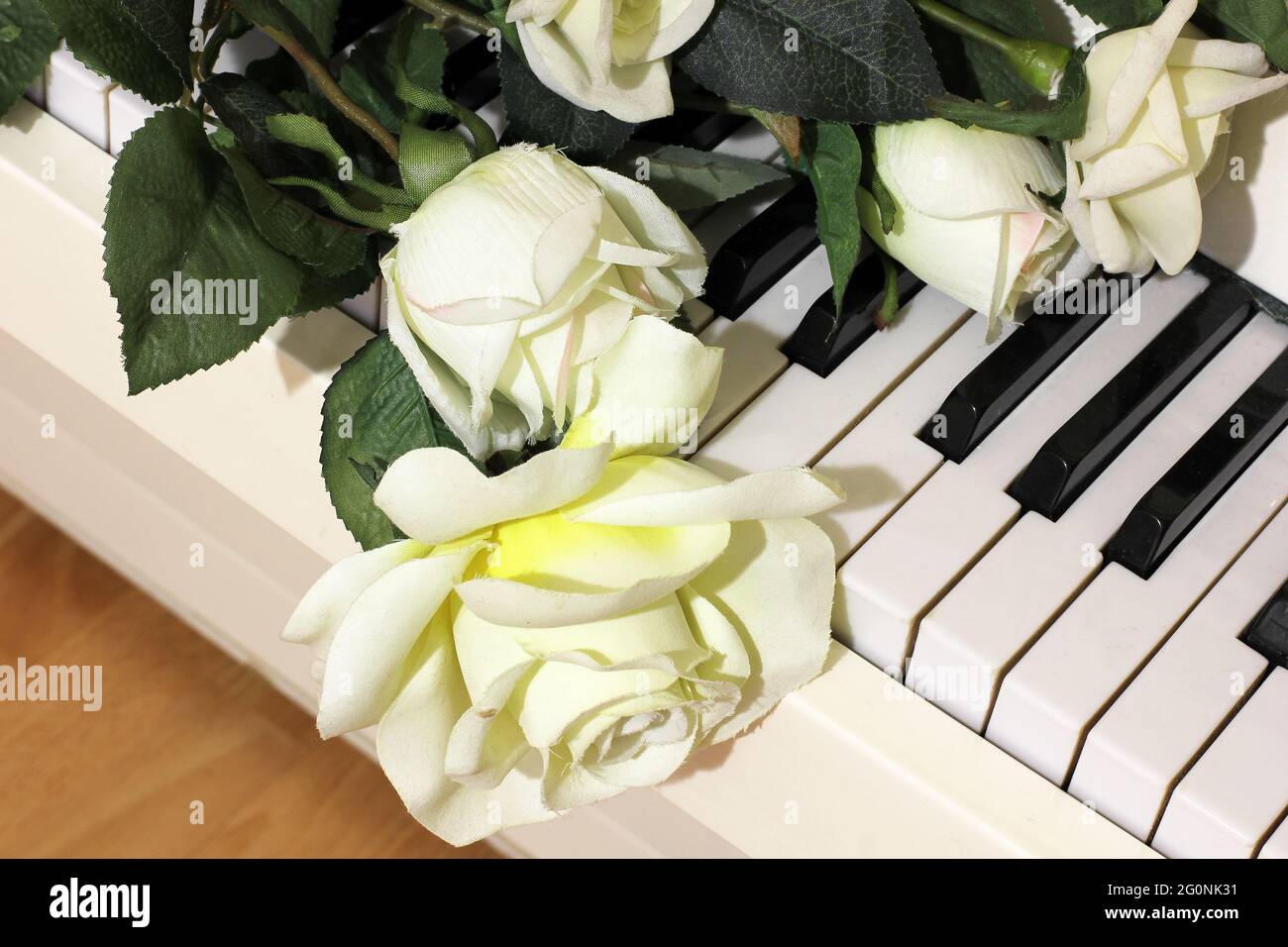 Vase with flowers and piano. Roses and musical instrument Stock Photo ...