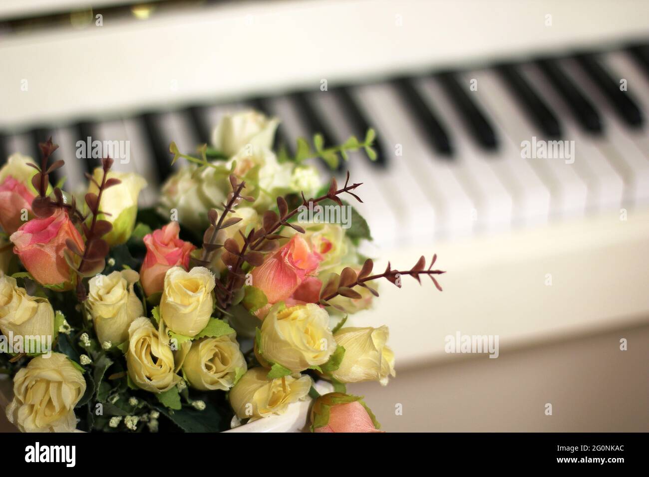 Vase with flowers and piano. Roses and musical instrument Stock Photo ...