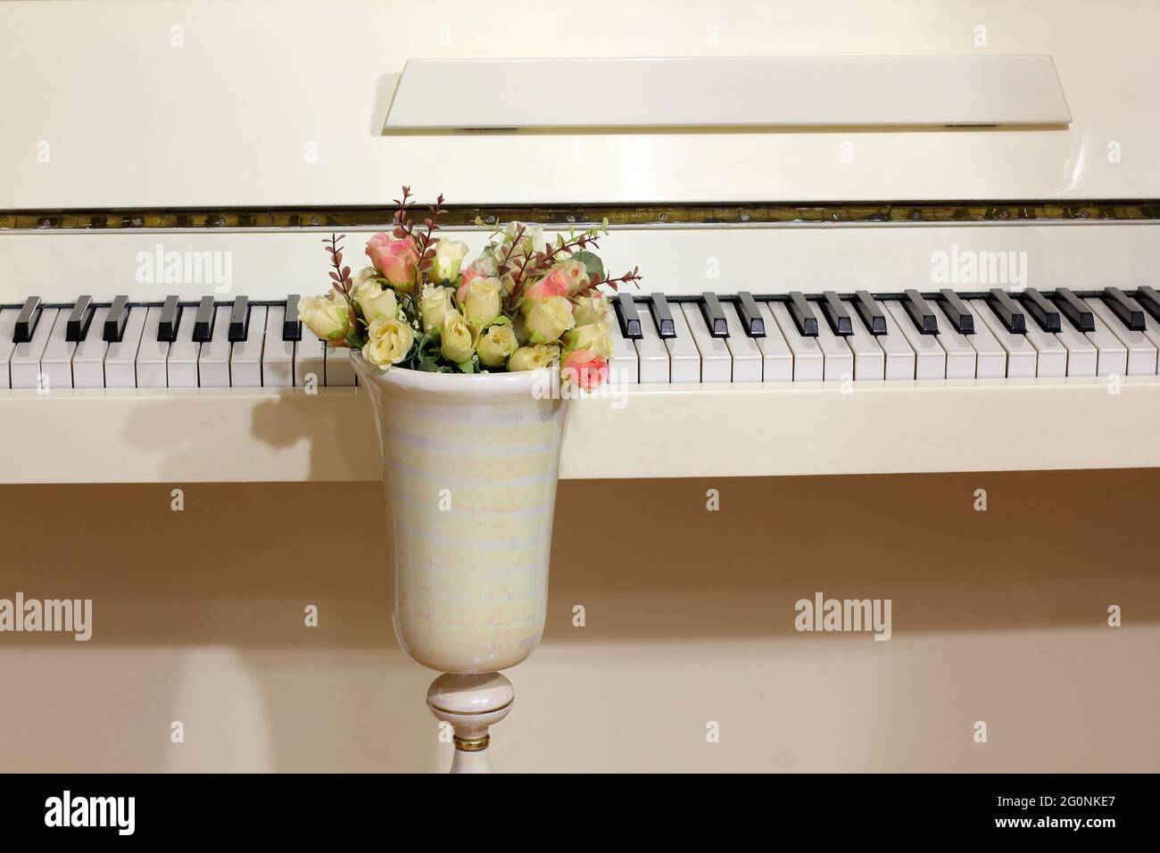 Vase with flowers and piano. Roses and musical instrument Stock Photo ...