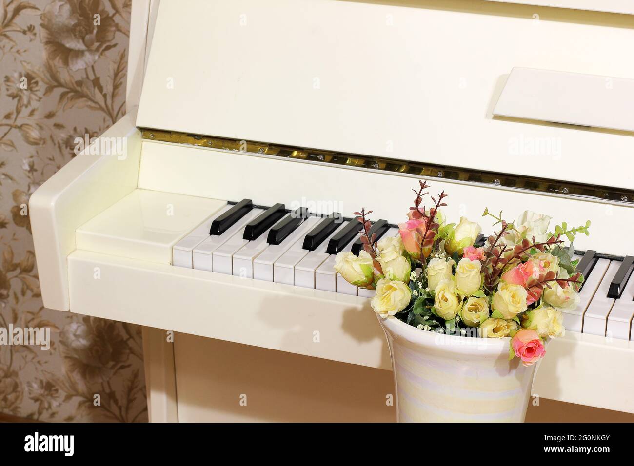 Vase with flowers and piano. Roses and musical instrument Stock Photo ...