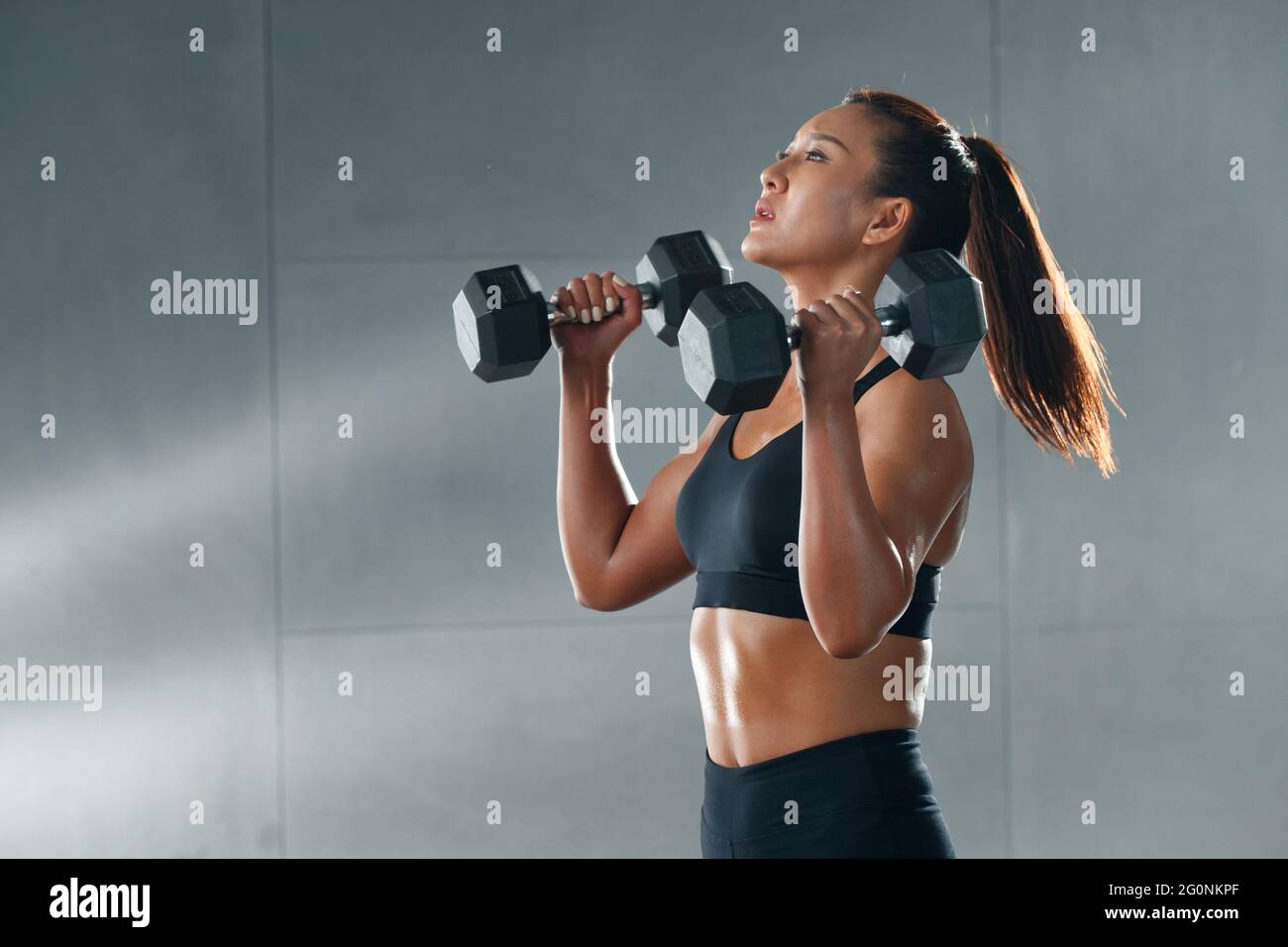 Young women at the gym dumbbell Stock Photo - Alamy