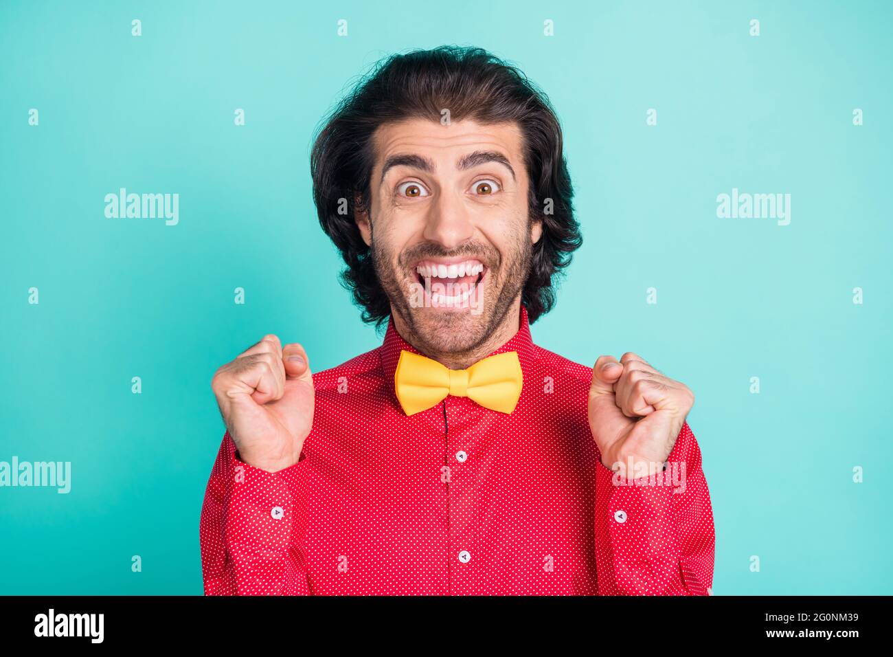 Photo of excited victorious young happy man raise fists unexpected win ...